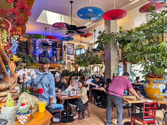 Step inside and the world unfolds&mdash;colorful parasols dance overhead while lush plants create a jungle-like oasis that whispers, "Stay awhile."