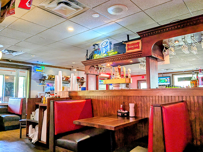 Classic red booths and wood paneling create that perfect neighborhood vibe&mdash;where conversations flow as easily as the gravy on your mashed potatoes.