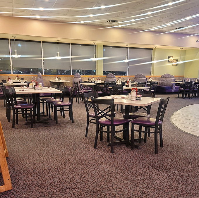 Purple chairs and pristine tables await hungry patrons. The spacious interior balances modern comfort with that timeless "everybody knows your name" diner vibe.
