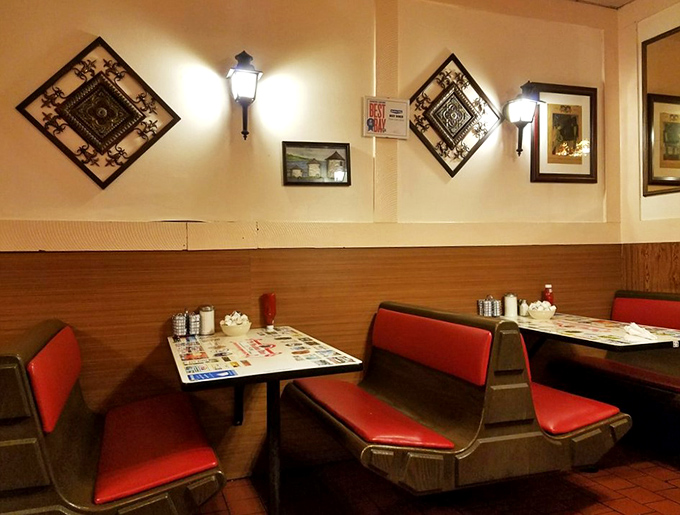 Classic red vinyl booths invite you to slide in and stay awhile, while vintage wall sconces cast that perfect golden glow over comfort food conversations.