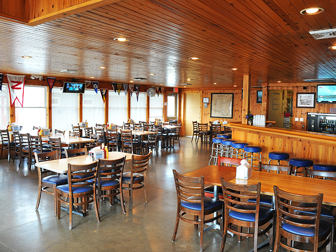 Step inside to a warm wooden embrace &ndash; knotty pine walls, blue-cushioned chairs, and that unmistakable vibe that says "island time starts now."