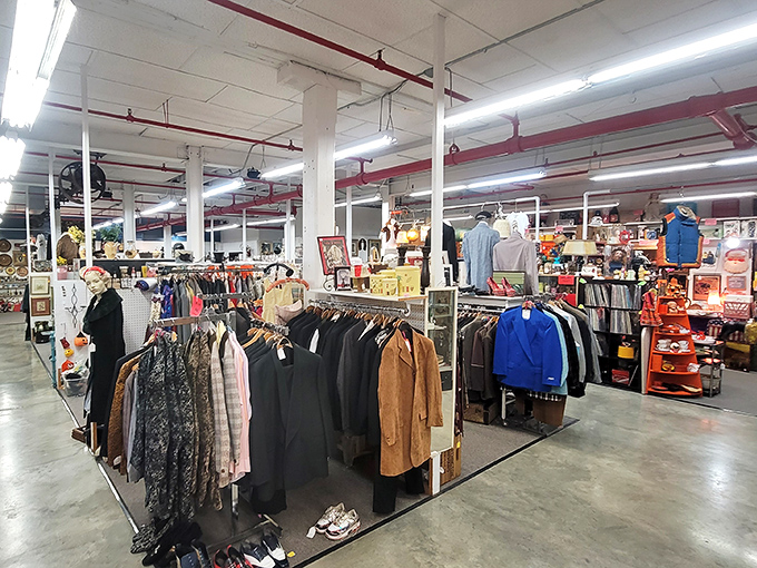 A labyrinth of vintage clothing racks stretches toward infinity, where someone's forgotten fashion statement becomes your next conversation piece.