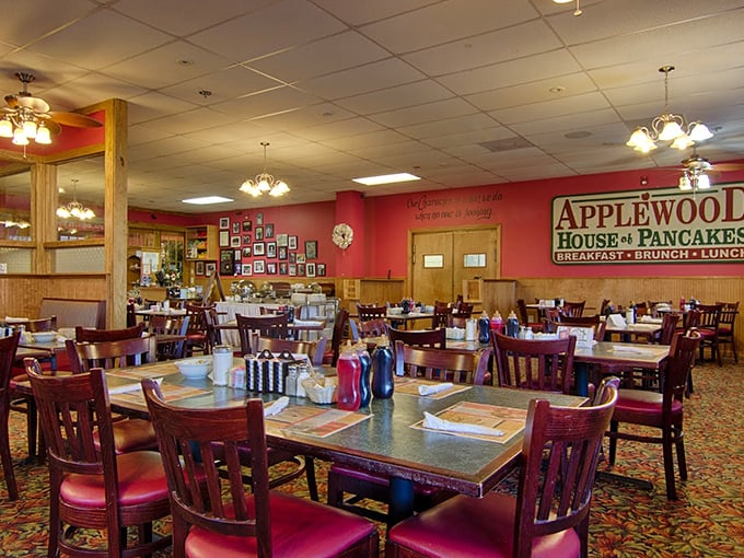Warm red walls, wooden accents, and comfortable seating create the perfect backdrop for the food drama about to unfold on your plate.