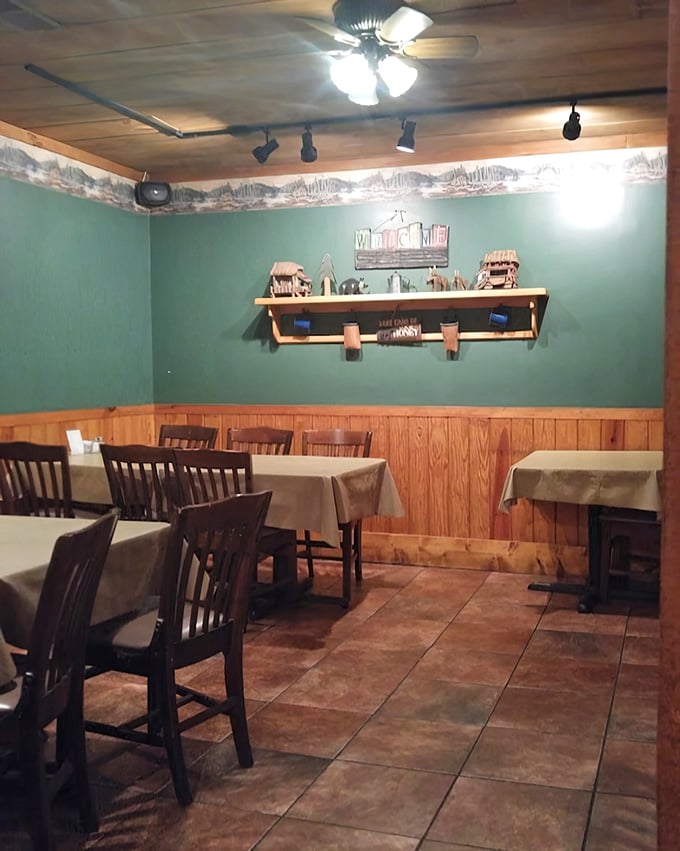 Teal walls meet wood paneling in this dining room where conversations flow as freely as the sweet tea.