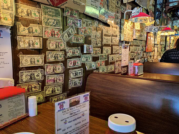 Dollar bills wallpaper the interior like a currency museum gone wild. Each signed bill tells a story of someone who thought, "This place deserves my Washington."