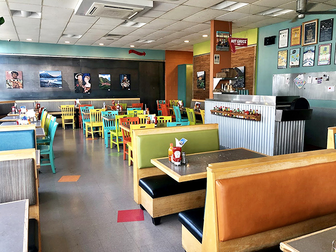 A kaleidoscope of colorful chairs and cozy booths creates the perfect backdrop for morning conversations and coffee revelations.