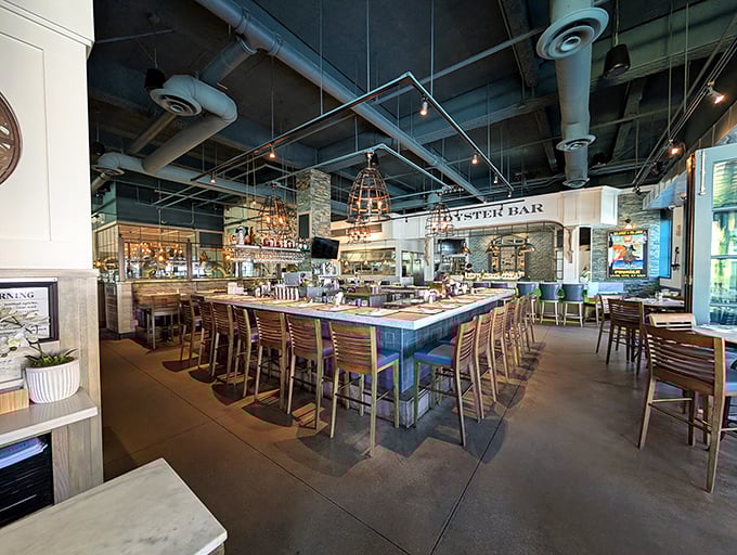 Industrial meets nautical in this thoughtfully designed interior. The oyster bar takes center stage, inviting diners to watch culinary magic happen beneath cage-style pendant lights.