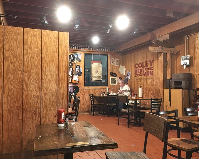 Sunlight streams through the windows, illuminating a dining space where wood-paneled walls tell stories of barbecue pilgrimages past.