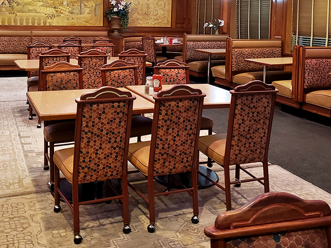 Rich wood paneling and patterned chairs create that perfect old-school diner ambiance&mdash;where comfort begins before the food even arrives.