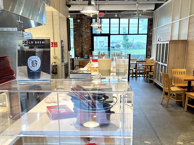 Inside, the clean, modern space balances efficiency with comfort—a doughnut laboratory where magic happens behind glass counters.