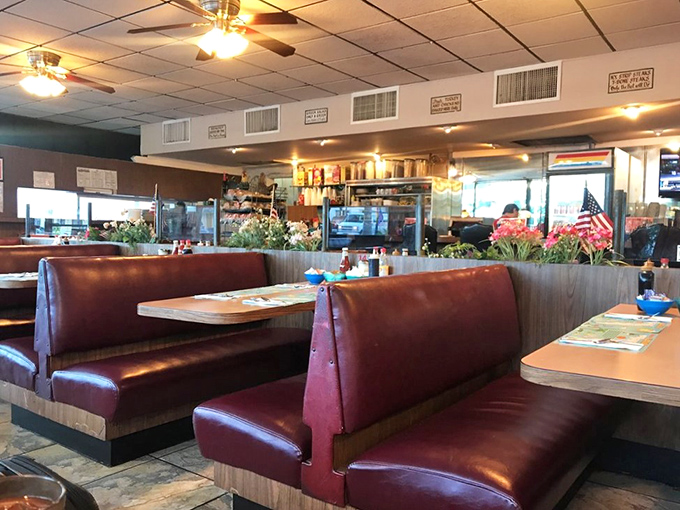 Classic burgundy booths invite you to slide in and stay awhile. This isn't Instagram-engineered nostalgia&mdash;it's the real deal that's earned every creak.