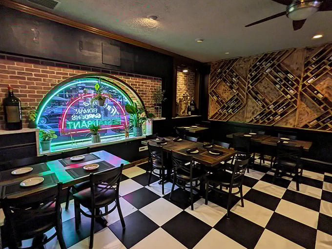 That classic checkered floor and neon glow create the kind of old-school Italian ambiance that makes every meal feel like a scene from "The Godfather"&mdash;minus the drama.