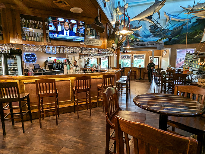 Nautical charm meets comfort in Benjamin's bar area, where mounted fish keep watchful eyes on patrons plotting their buffet strategy.