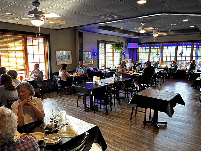 Inside, ceiling fans lazily spin above comfortable seating where conversations flow as freely as the iced tea. Coastal comfort without the sand in your shoes.