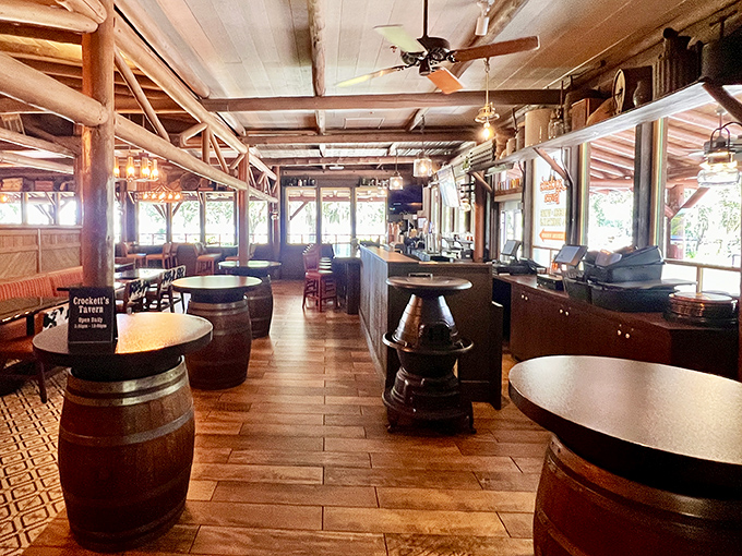 Barrel tables and exposed beams create a saloon-meets-comfort-zone vibe where breakfast dreams are hatched and pancake stacks disappear mysteriously.