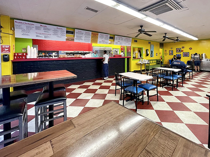 Classic red and yellow checkerboard floors set the stage for breakfast theater. This isn't trendy minimalism&mdash;it's diner maximalism at its finest.