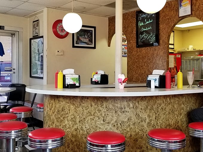 Pull up a cherry-red stool at the counter where Kansas food dreams come true. The classic condiment lineup stands ready for burger customization duty.