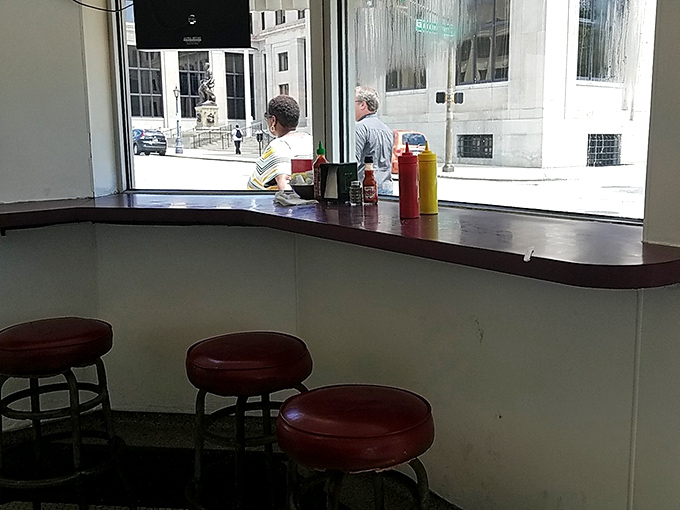 Counter culture at its finest&mdash;red vinyl stools await patrons while condiments stand ready for the burger perfection about to unfold.