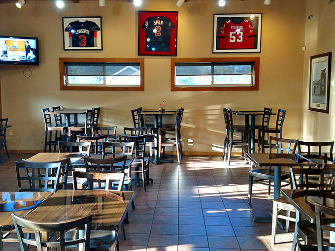 Sports memorabilia and simple furnishings create the perfect distraction-free zone where the food remains the undisputed star of the show.