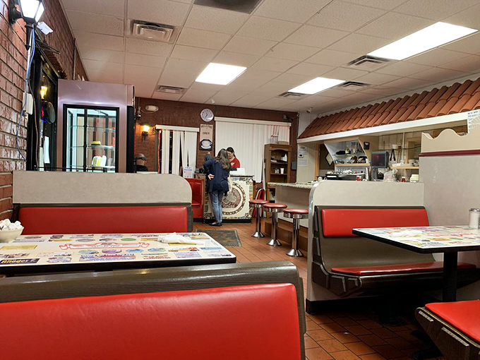 Classic red vinyl booths and wood paneling create the perfect backdrop for conversations that meander from politics to pie without missing a beat.