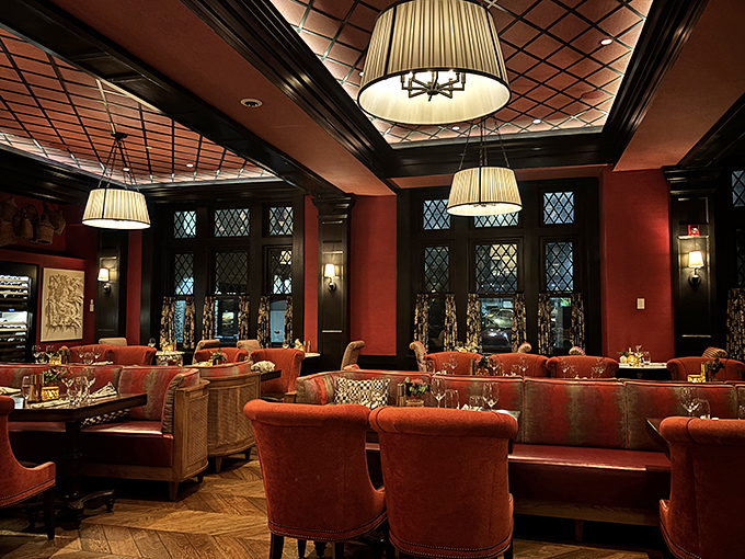 Rich red walls and plush seating create the perfect backdrop for your "I can't believe I ate the whole pizza" moment.