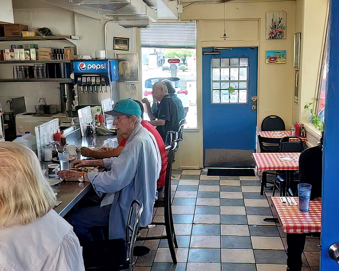 Inside, the classic checkerboard floor and red-checkered tablecloths create that timeless diner atmosphere where good conversations and better food are always on the menu.