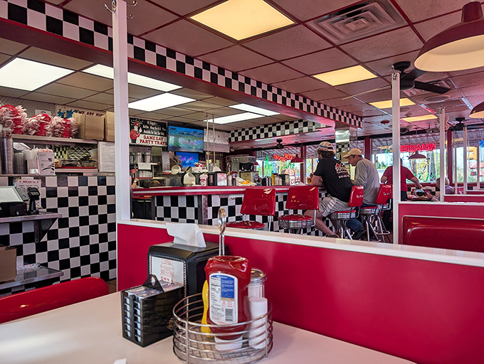 Checkerboard patterns and cherry-red booths create the perfect backdrop for your food fantasies. This isn't decoration&mdash;it's a declaration of diner devotion.