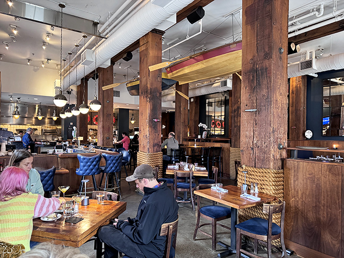 Massive wooden beams and nautical rope details transform this former warehouse into a seafood sanctuary where comfort meets coastal elegance.