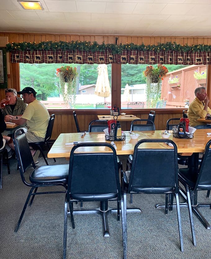 Wood paneling, plaid valances, and hanging plants create that classic Northwoods dining atmosphere where conversations flow as freely as the coffee.