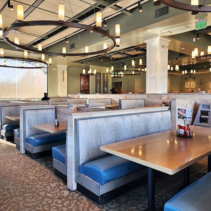 The dining room's elegant blue booths and warm lighting create an atmosphere that says, "Stay awhile, honey&mdash;there's plenty more coming."