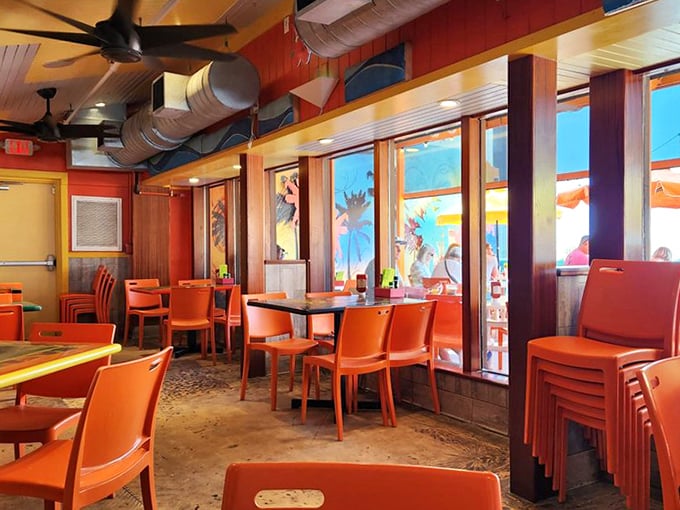 Orange chairs pop against wooden accents in this casual dining space where flip-flops are the dress code and seafood is the language.