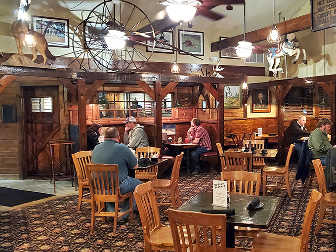 Step inside and you're transported to a rustic wonderland where wooden beams, wagon wheels, and stable-like booths create the perfect backdrop for serious eating.