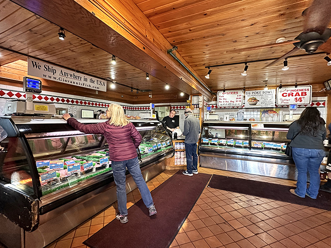 Inside, the warm wood-paneled ceiling hovers above glass cases where the morning's catch awaits its destiny on your plate.