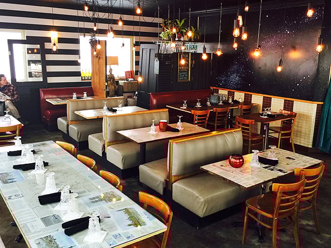 Inside, Edison bulbs cast a warm glow over booths lined with newspaper-topped tables, while a cosmic mural reminds you the universe is vast&mdash;but good food is universal.