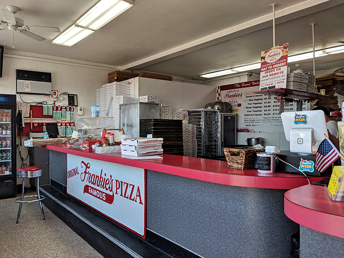 Behind that iconic red counter, pizza magic happens with the efficiency of a NASCAR pit crew and the precision of Swiss watchmakers.