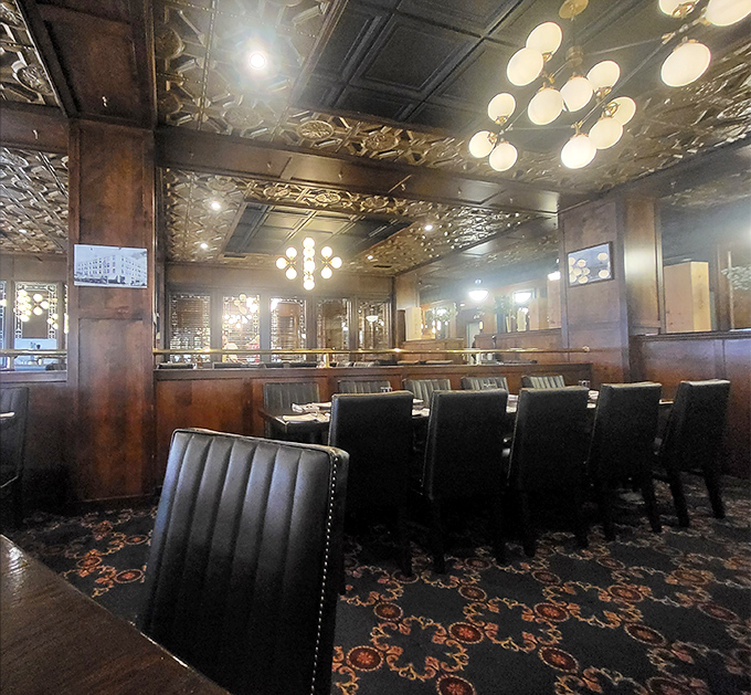 Rich wood paneling meets ornate tin ceilings in this dining room that whispers "special occasion" while still letting you be comfortable in your good jeans.