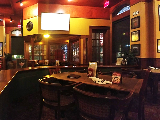 Warm wood tones and cozy seating create that authentic pub atmosphere where strangers become friends and friends become family.