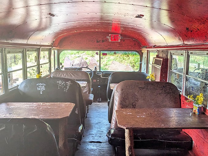 Inside the converted school bus, graffiti-covered tables tell stories of visitors past. Dining here isn't just a meal&mdash;it's joining a rolling history of hungry travelers.