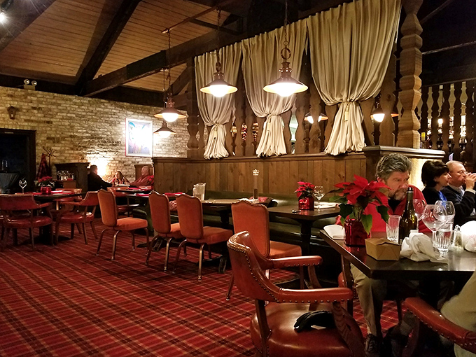 Plaid carpeting, exposed brick, and warm wooden accents create the kind of cozy dining room where memories are made and steaks are savored.