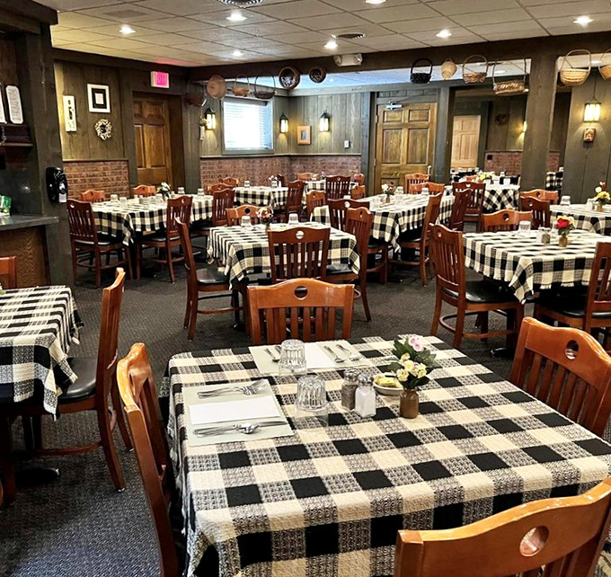 Black and white checkered tablecloths set the stage for culinary drama in this wood-paneled dining room where conversations flow as freely as old fashioneds.
