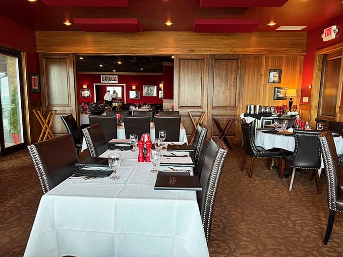 Rich red walls and warm wood paneling create the perfect atmosphere for serious steak business &ndash; no Instagram lighting needed.
