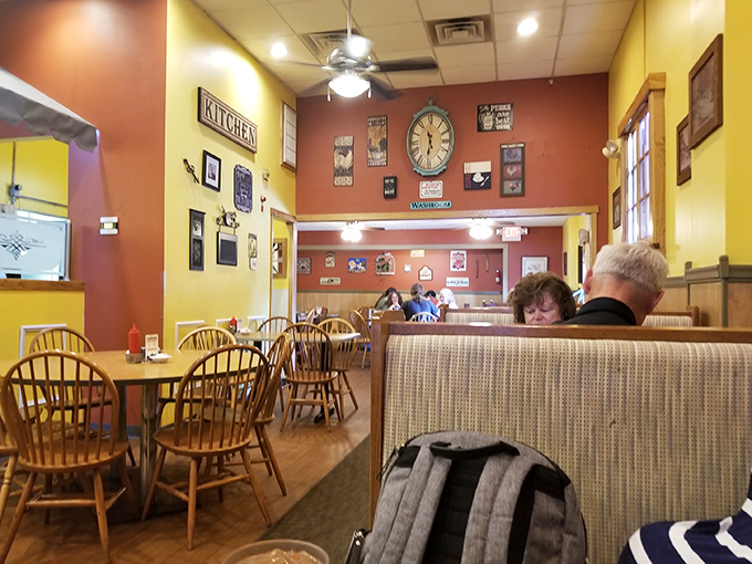 Warm yellow and red walls create that "grandma's kitchen" vibe, where wooden chairs have supported generations of satisfied breakfast enthusiasts.