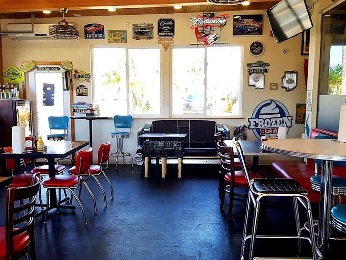 Classic Americana meets Florida sunshine inside, where vintage car memorabilia shares space with comfortable booths. The blue chairs aren't just seats&mdash;they're time machines to simpler days.