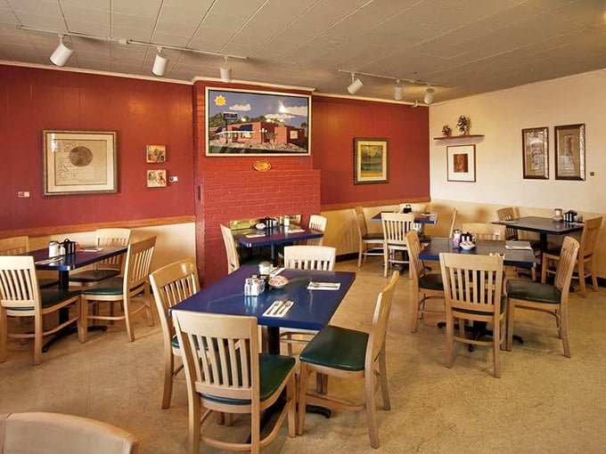 The dining room's warm red walls and local artwork create that perfect "welcome home" feeling, even if it's your first visit. 