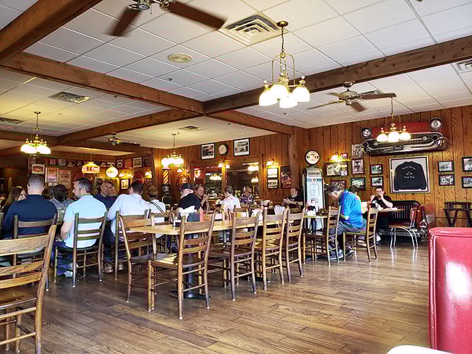 Inside, wood-paneled walls tell stories older than many of the diners, while ceiling fans lazily push around the intoxicating aroma of hickory smoke and Southern hospitality.