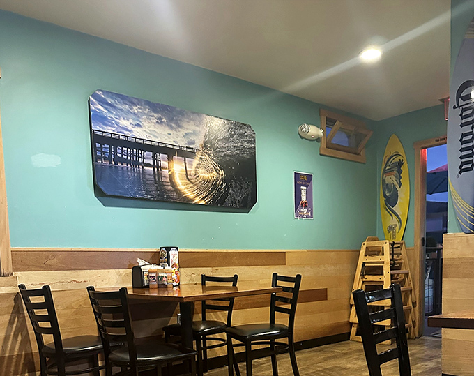Surfboards and ocean photography adorn aqua walls, creating that quintessential SoCal vibe. It's like dining inside a perfect beach day.