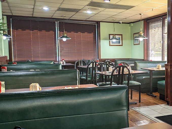 Classic green vinyl booths and wood paneling create that perfect nostalgic diner atmosphere. This isn't retro by design&mdash;it's authentic by persistence.