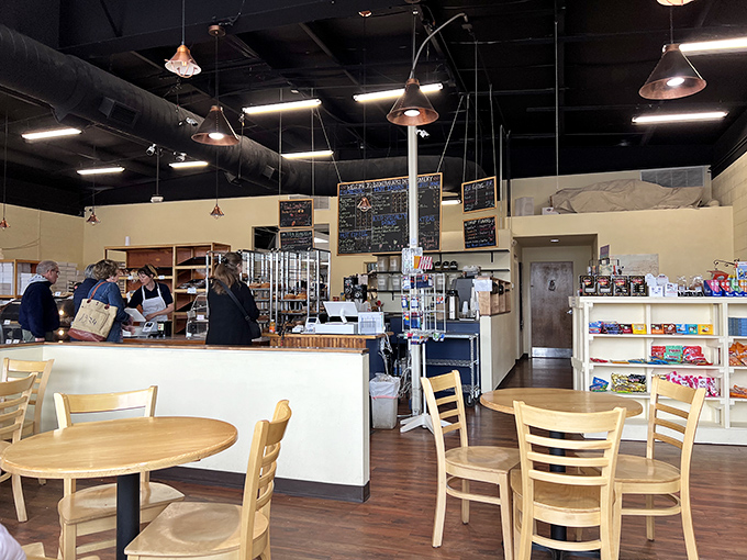 Simple wooden tables and warm lighting create the perfect stage for pastry drama to unfold. The display case is the real star here.