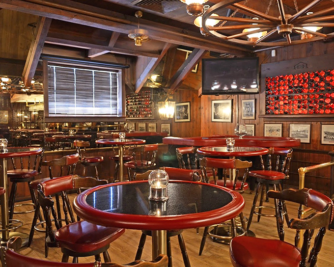 Wood beams, warm lighting, and those iconic antler chandeliers create the perfect atmosphere for serious steak consumption.