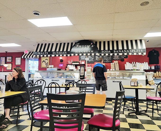 The checkered floors and pink seats create a backdrop straight from a Norman Rockwell painting, only with better food.